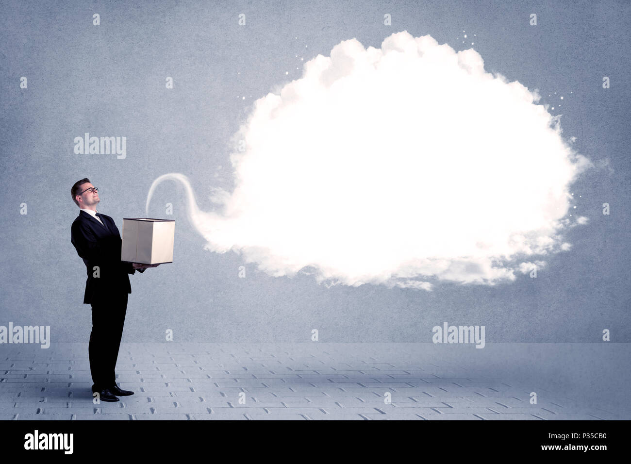 A young cheerful business person holding a cardboard box with ...