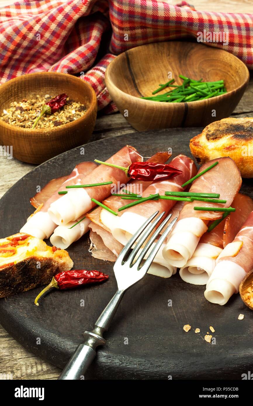 Thinly sliced German black forest ham with sliced ciabatta bread ...