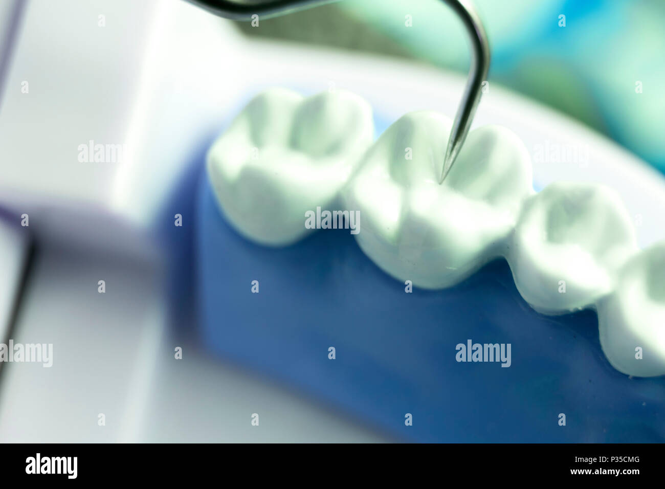 Dentist cleaning teeth with titanium metal tooth pick instrument to ...