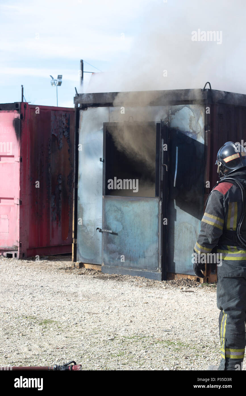 Firefighter putting out fire training station extinguisher backdraft ...