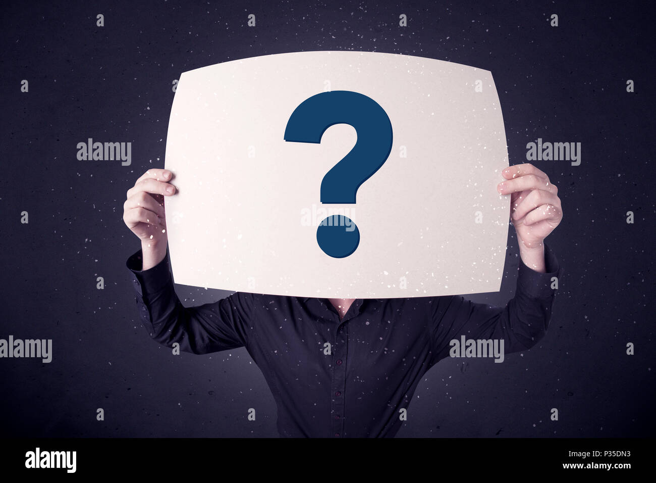 Young businessman hiding behind a question mark drawn on paper Stock ...