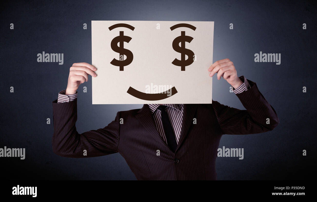 Young casual businessman hiding behind a greedy face drawing on ...