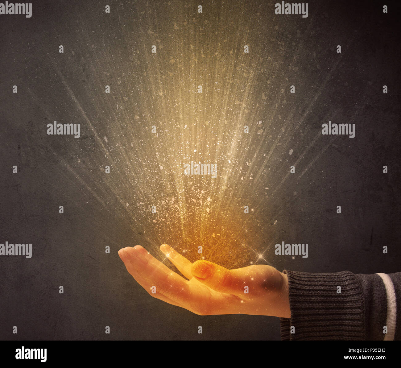 Yellow ray of light coming from a young hand Stock Photo - Alamy