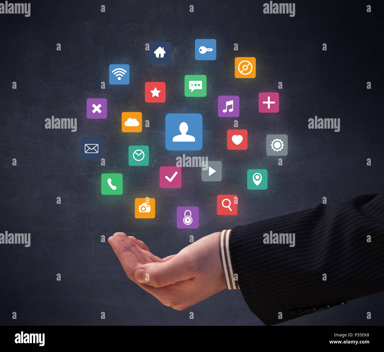 Colorful applications hovering over young hand Stock Photo - Alamy
