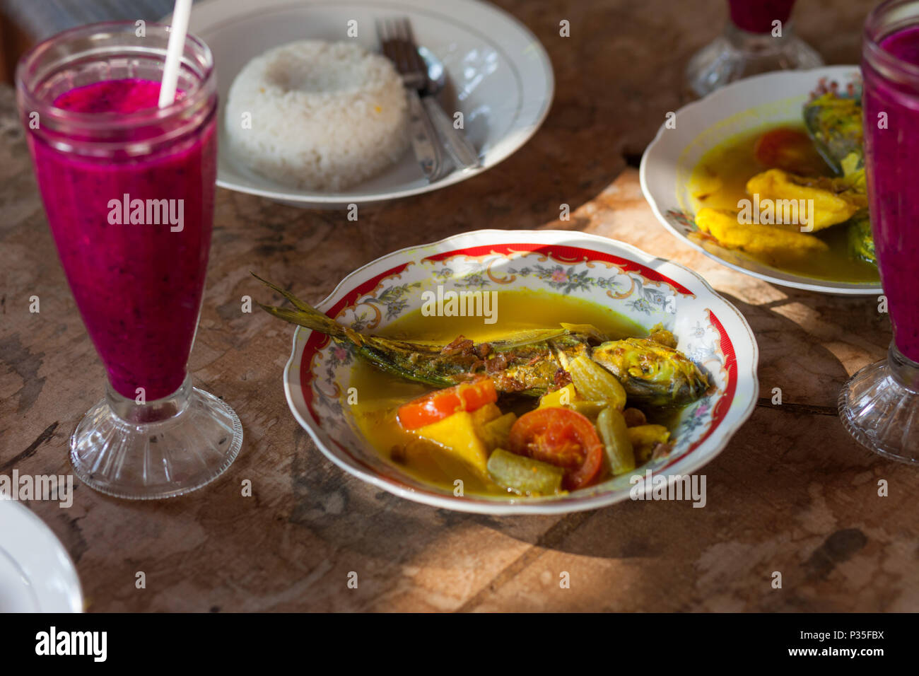 Traditional Indonesian fish curry with rice and dragonfruit juice Stock ...