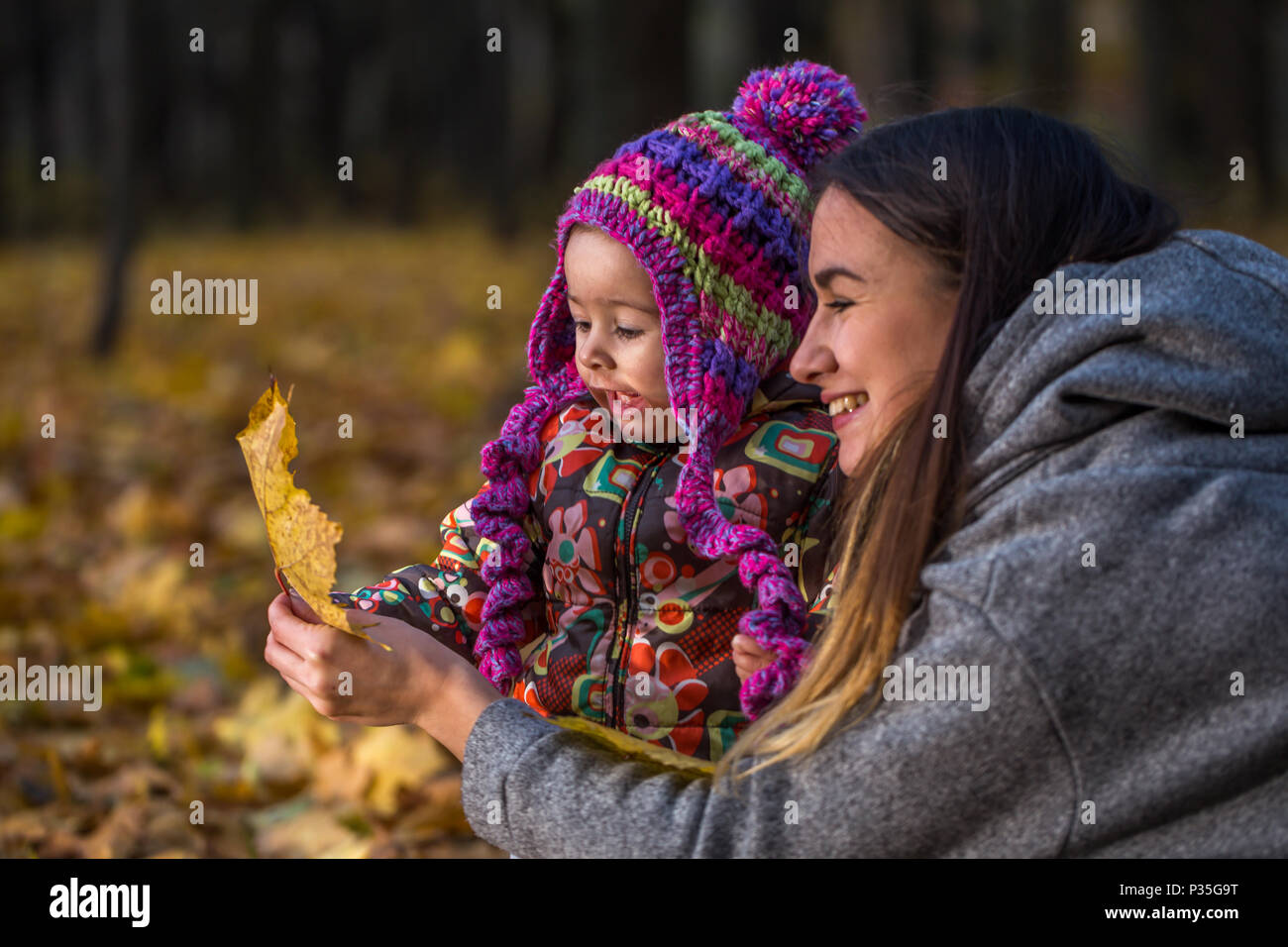 happy seed in autumn forest, a small child with my mother, autumn ...