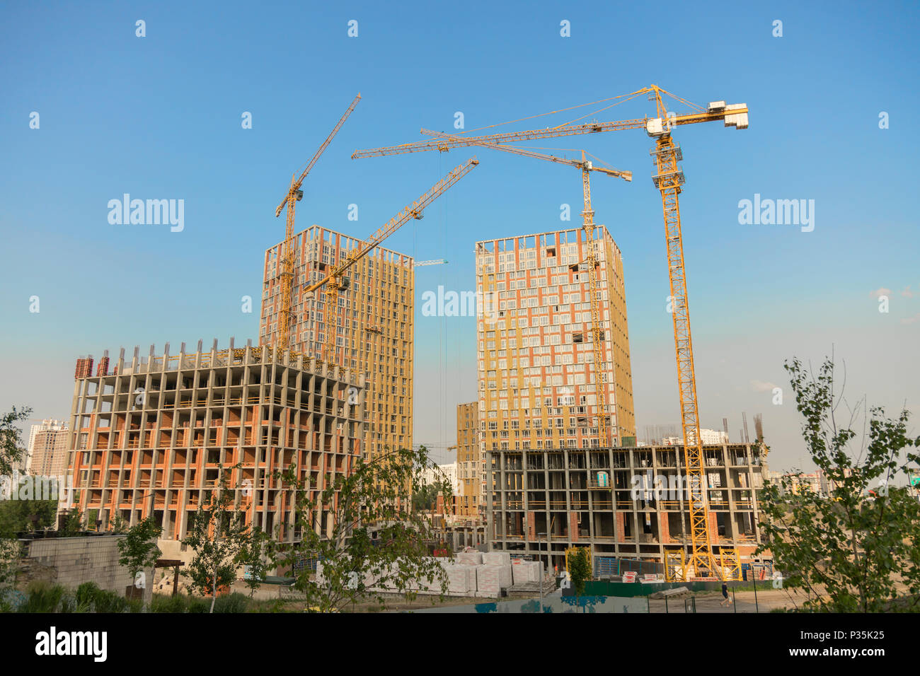 Hoisting crane and new multi-storey building. ndustrial background ...