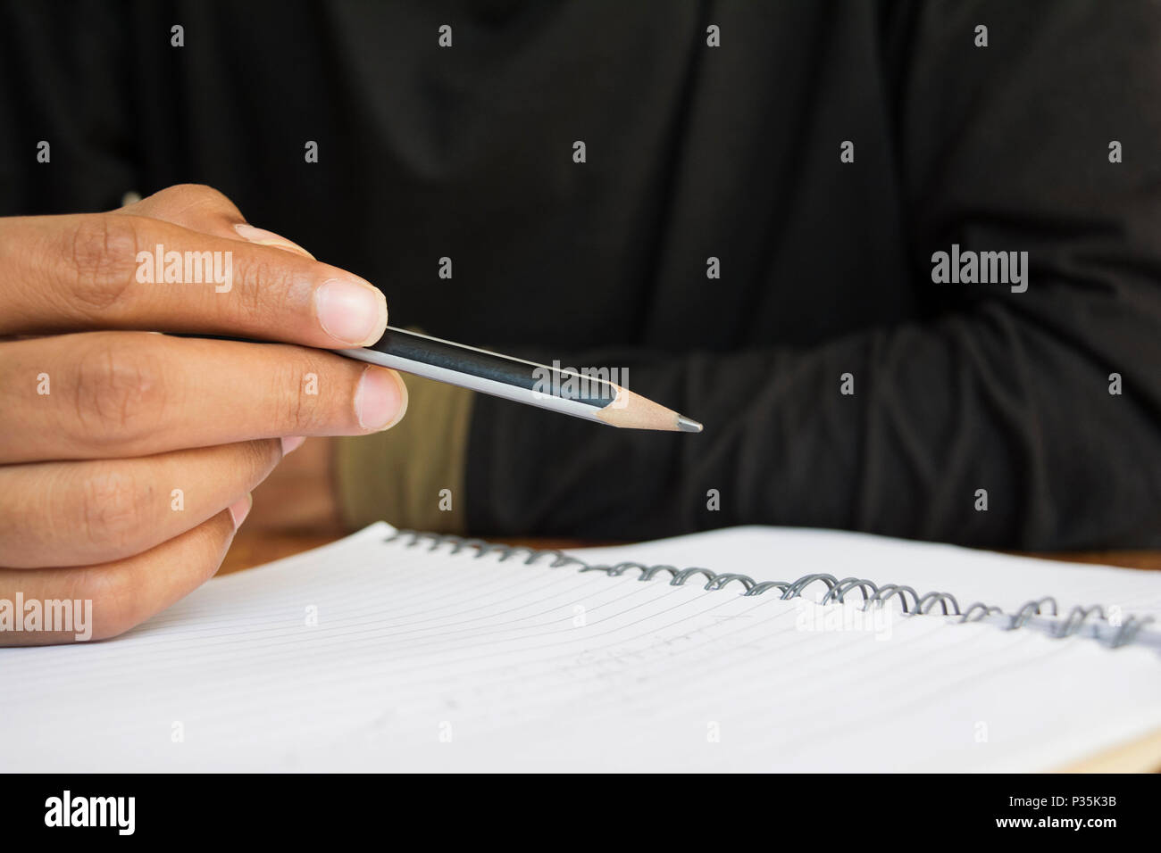 man writing a note with pencil Stock Photo - Alamy