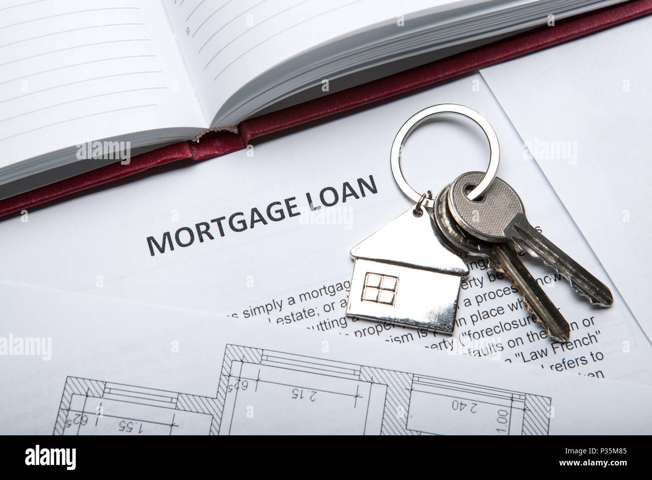 apartment keys with house key chain and a mortgage loan document and a ...