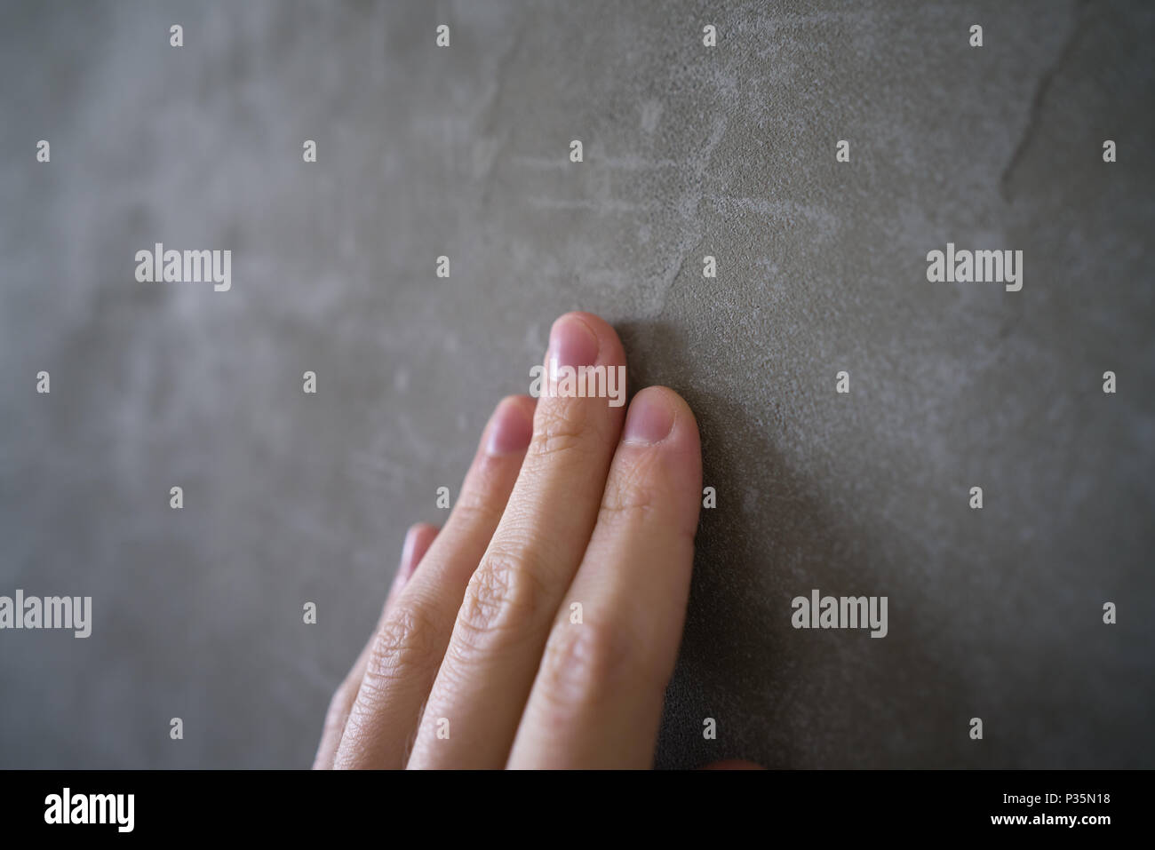 young man hand touching concrete wall, shallow focus Stock Photo - Alamy