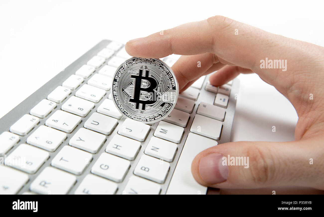 Hand holds silver coin hi-res stock photography and images - Alamy