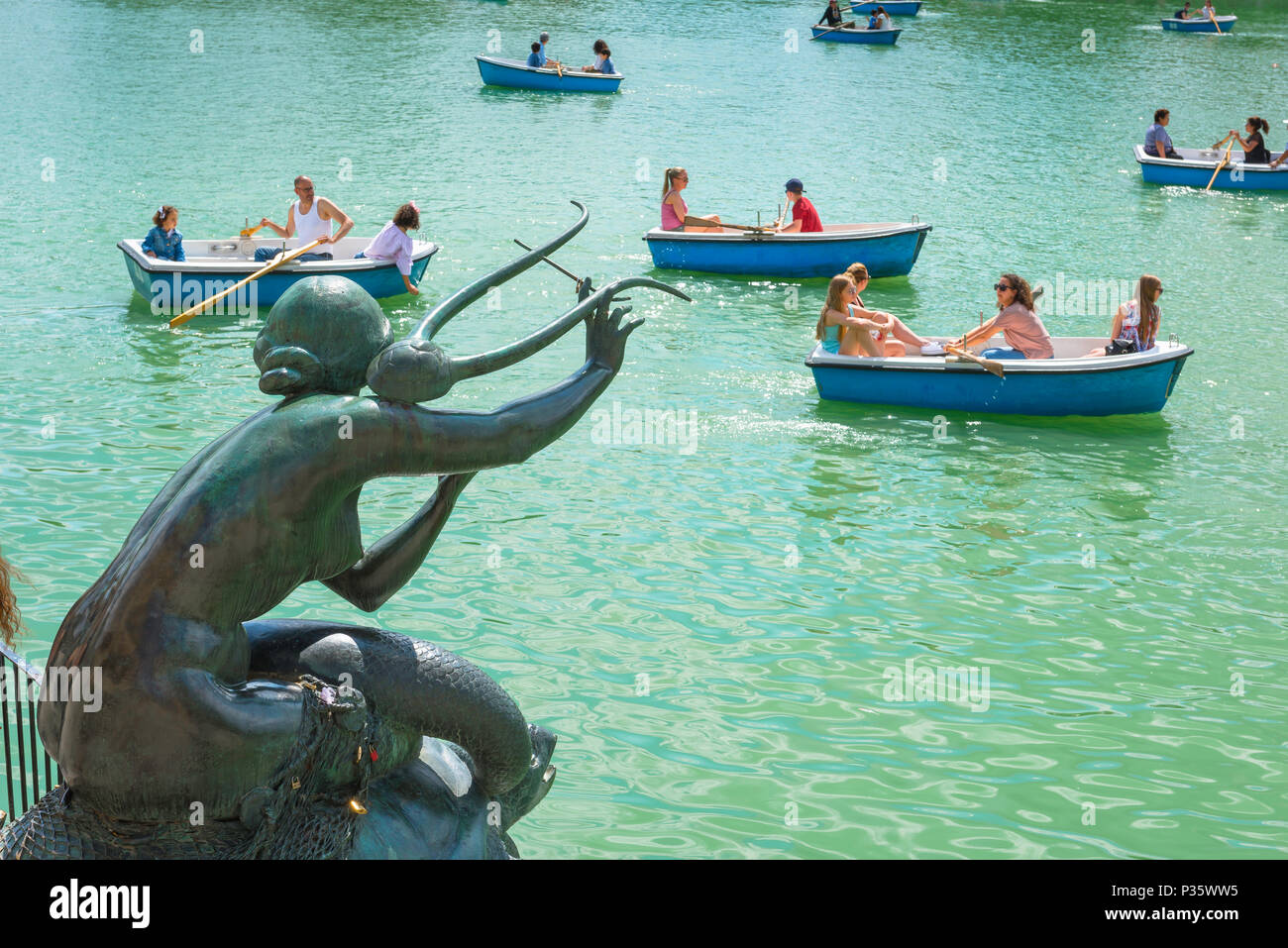 Madrid Retiro park lake, view of people rowing boats on a summer ...