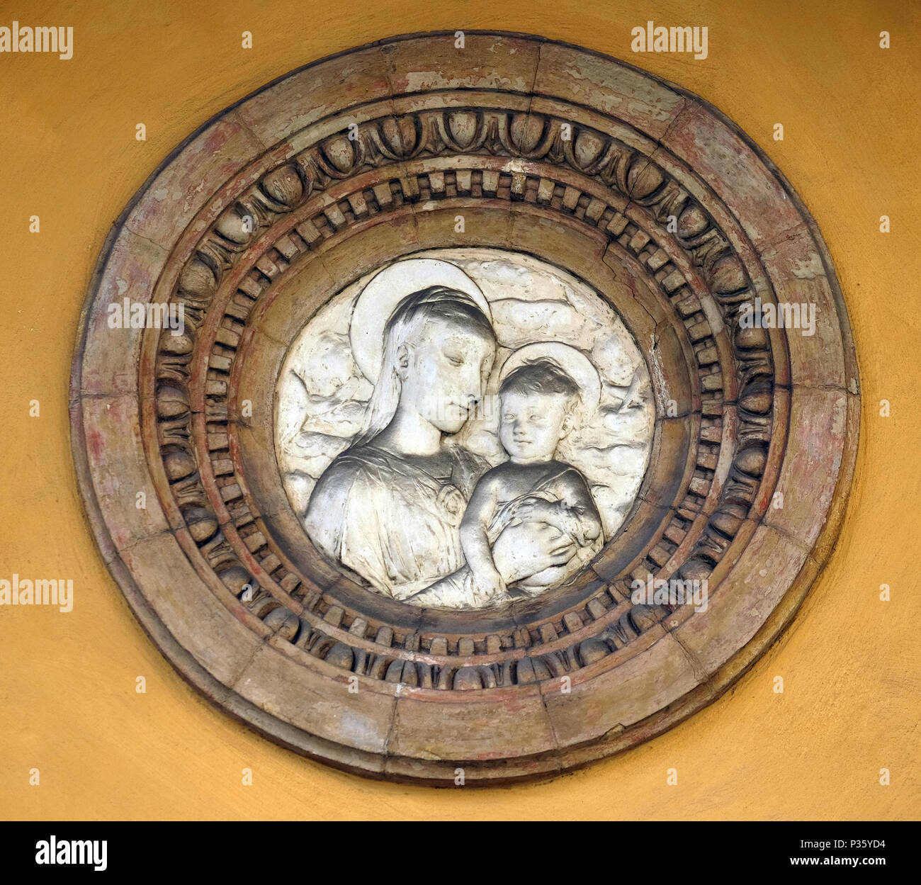 Virgin Mary with baby Jesus, relief on house facade in Modena, Italy ...