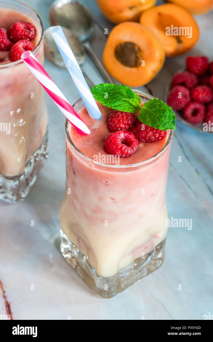 Peach and raspberry melba smoothie garnished with fresh fruit and mint ...