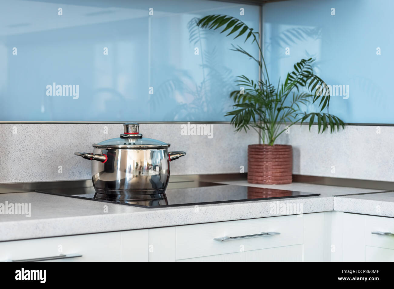 Stainless steel pot on induction electric hob Stock Photo - Alamy