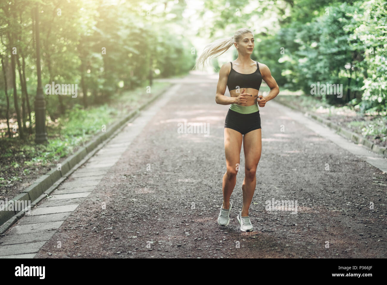 Young Woman Running. Beautiful fit Girl. Fitness model outdoors. Weight ...