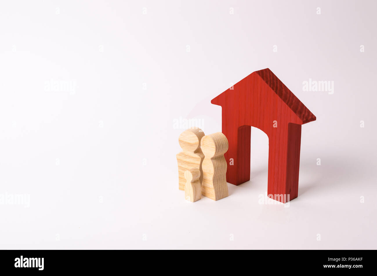 Figures of people stand near a wooden house on a white background. A ...