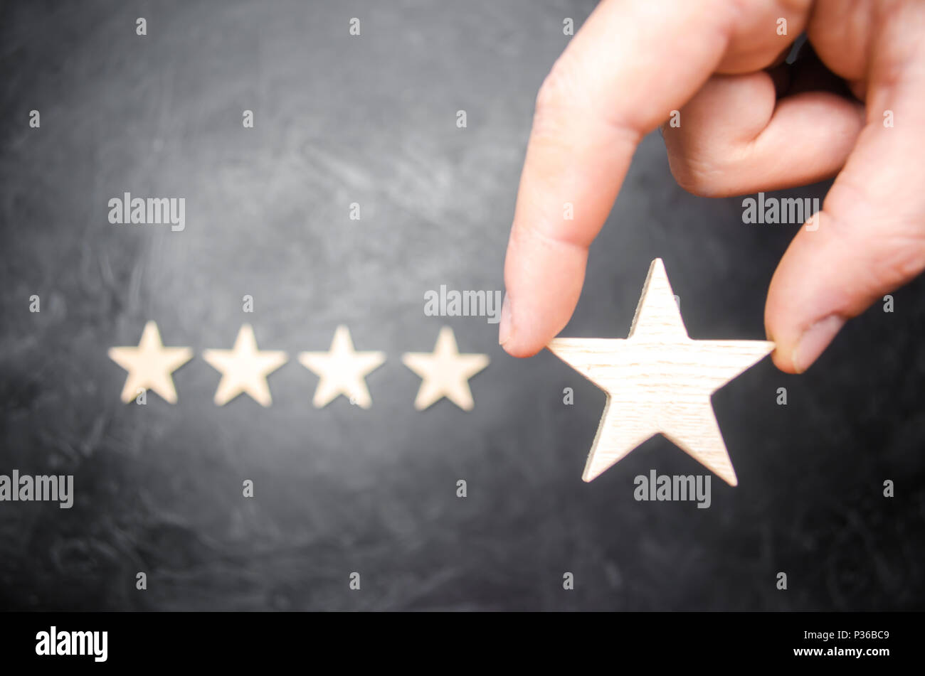 The businessman's hand in the suit holds the fifth star. Get the fifth ...