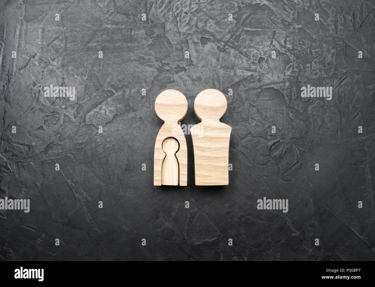 Wooden figurines of parents with the shape of a child inside the woman ...