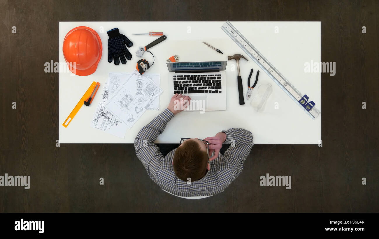 Young architect having important phone call about drawings Stock Photo ...