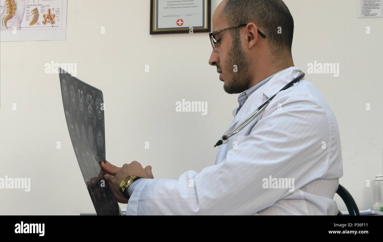 Young radiologist examining brain computed tomography Stock Photo - Alamy