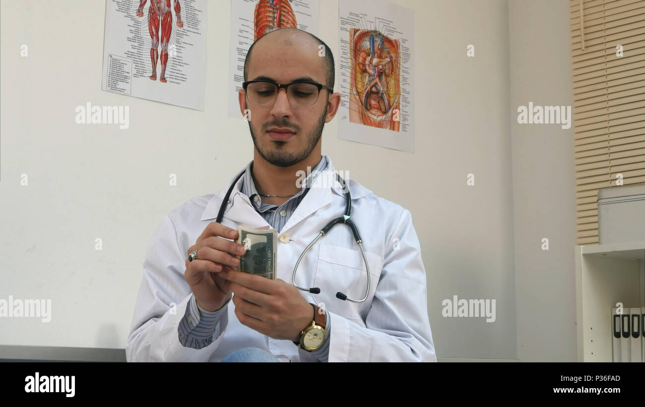 Doctor counting money in medical hi-res stock photography and images ...
