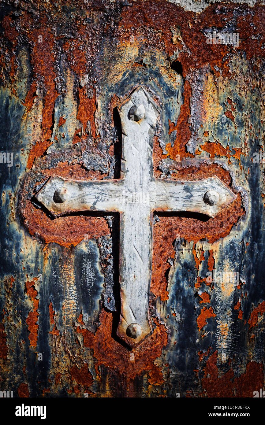Old Christian cross with dramatic, rusty metal gloomy background with ...