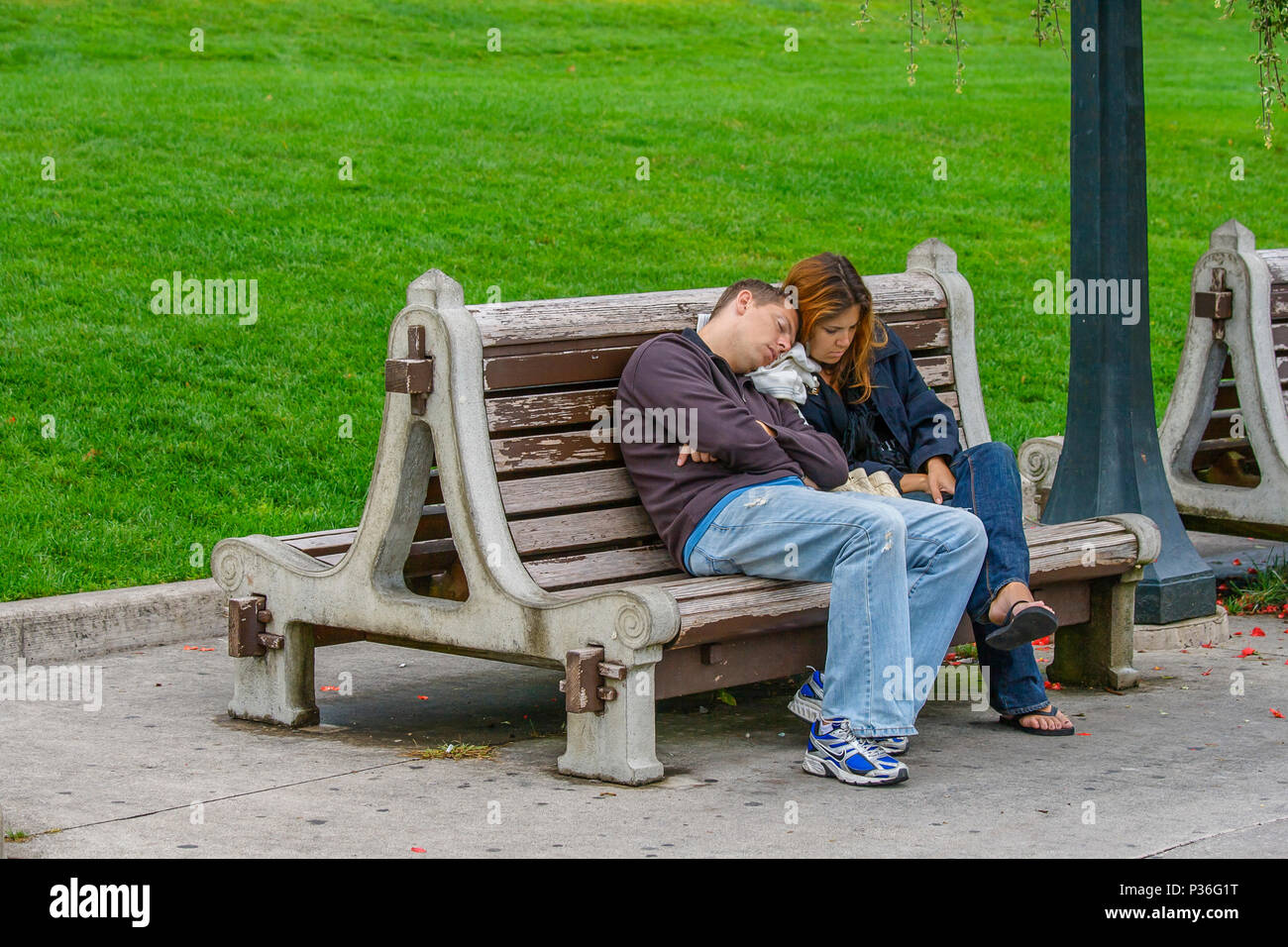 Boy sleeping on park bench hi-res stock photography and images - Alamy