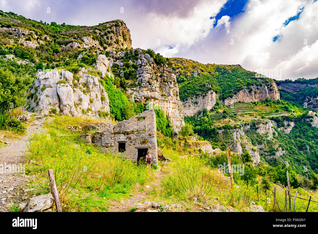 A woman explores an old house along the Walk of the Gods, also known as ...