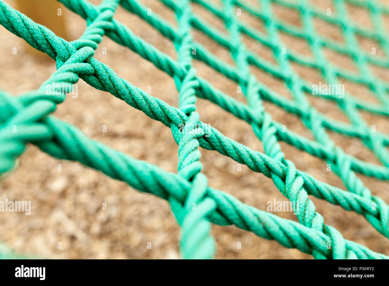 Rope mesh with blurry background. It is a green rope mesh in a ...