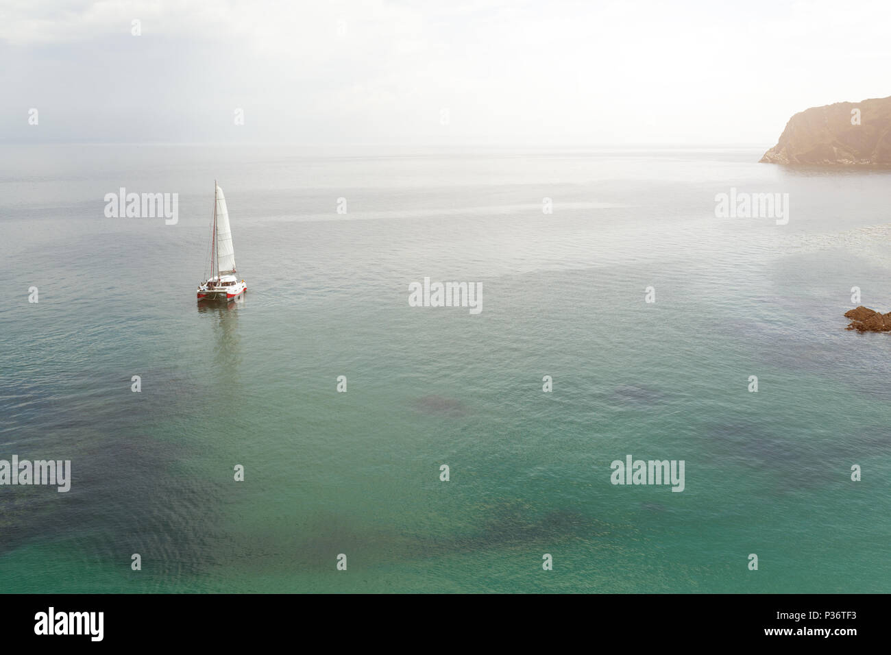 Panoramic view of Pacific Ocean blue transparent water, a white sport ...