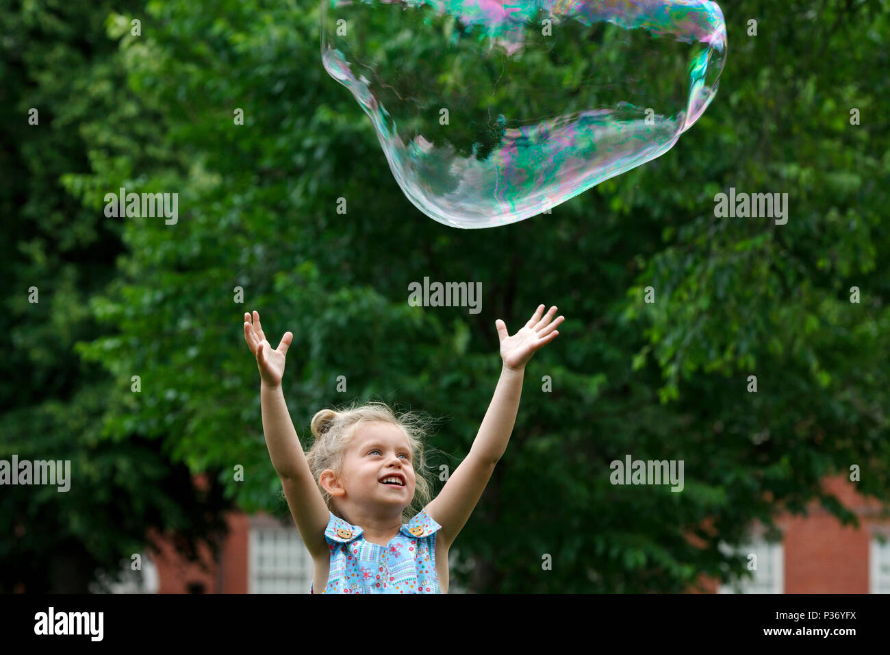Children chasing bubbles created by a street performer on Boston Common ...