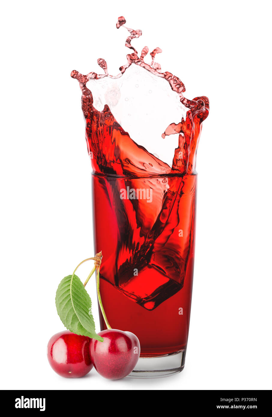 Splash of cherry juice in transparent glass with two cherries isolated ...