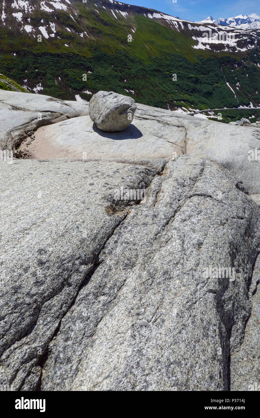 Glaciated granite slab with erratic boulder left by glaciers, Furka ...