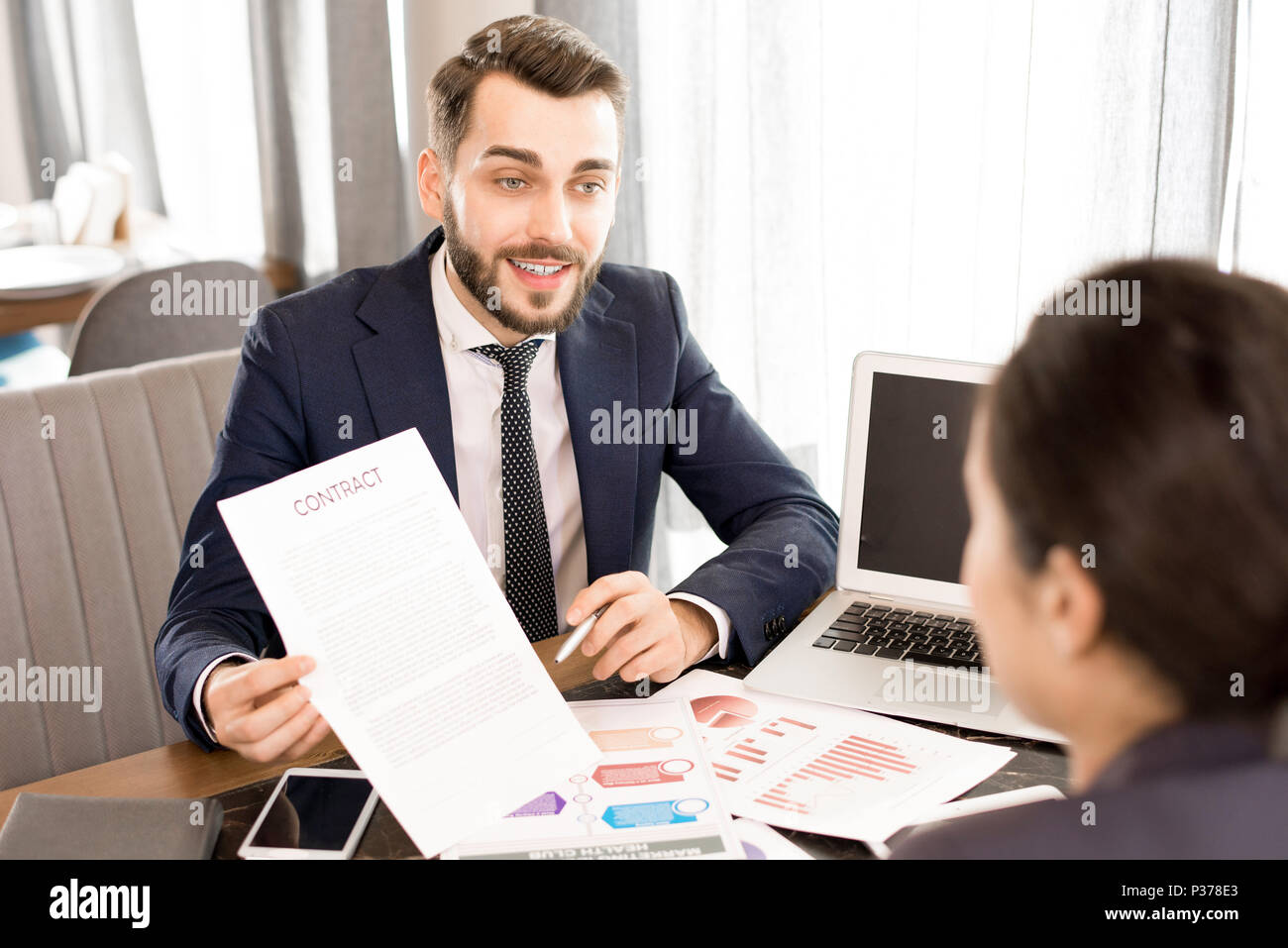 Confident businessman showing contract to colleague Stock Photo - Alamy