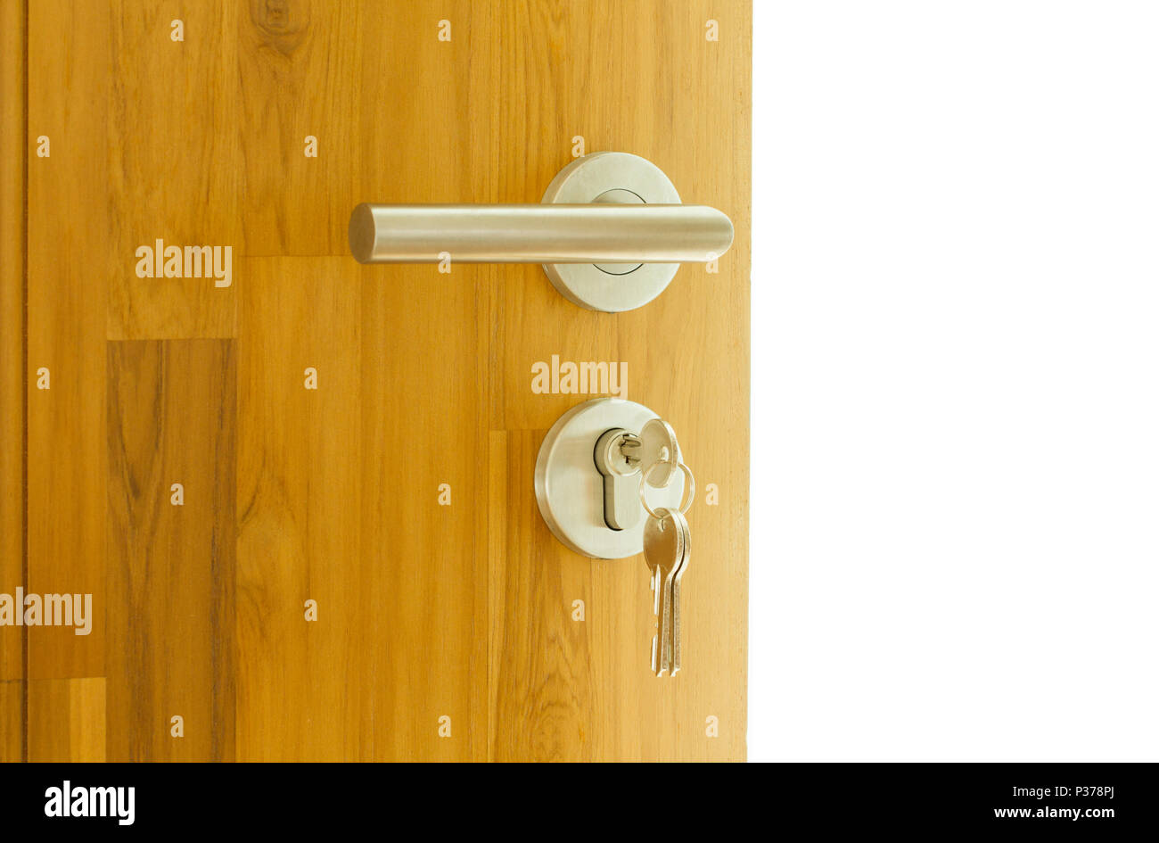 Modern style door handle on wooden door with key Stock Photo - Alamy