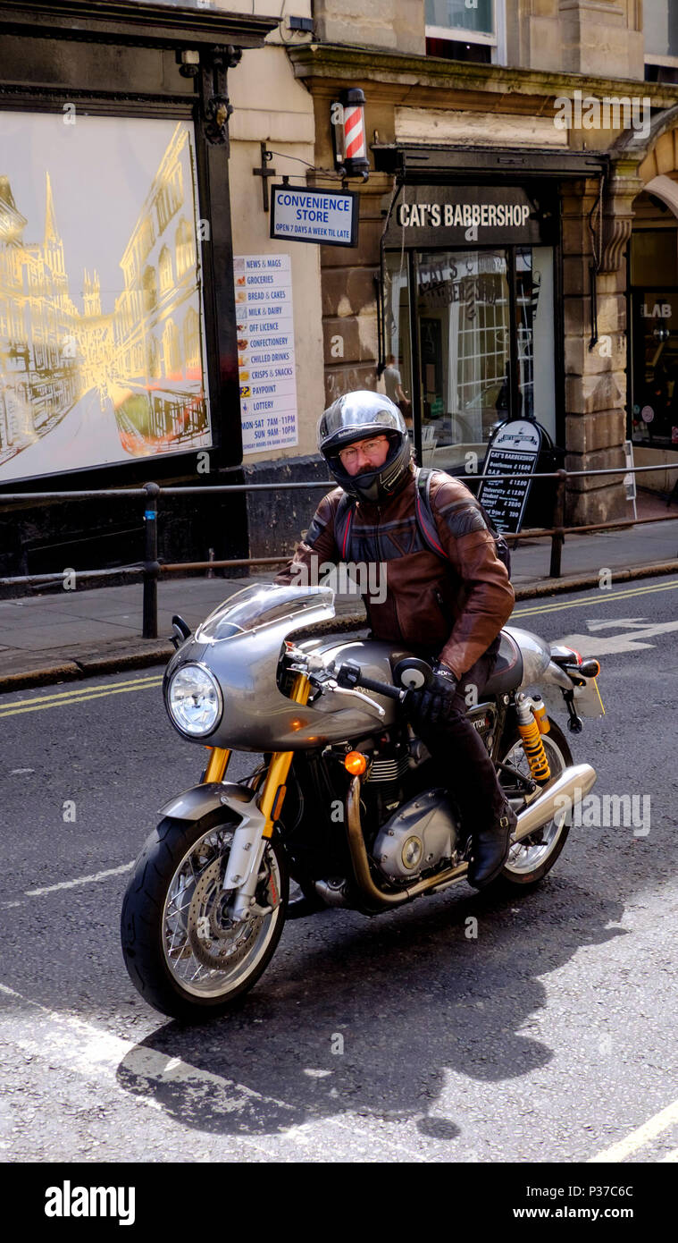 Man riding a Triumph Truxton motorbike in Bath Somerset england UK ...