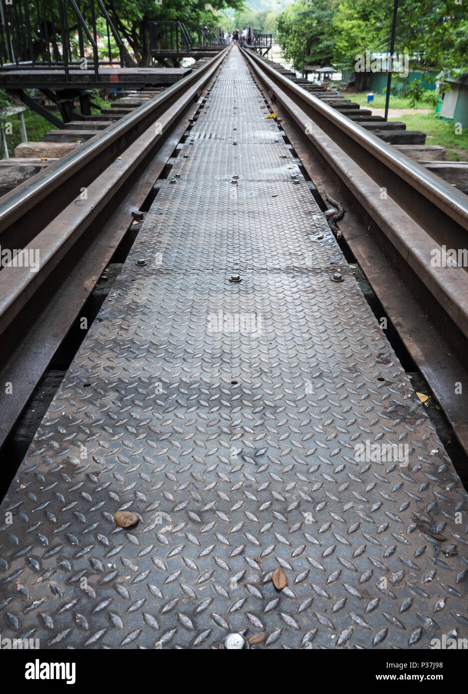 Closeup of the metal pathway on the old railway bridge with the blur ...