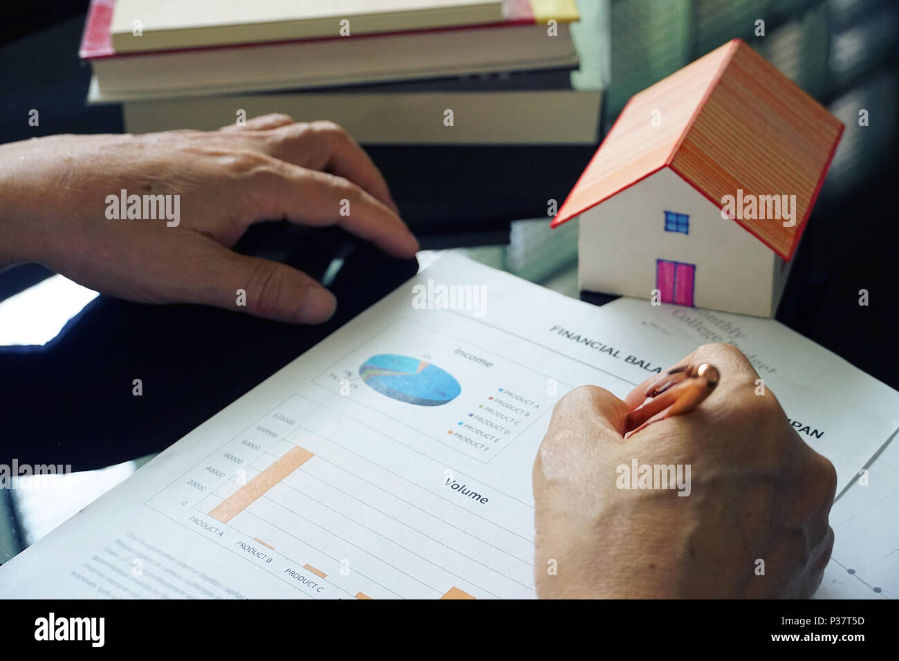 Hand sign property agreement on the table which have house model and ...