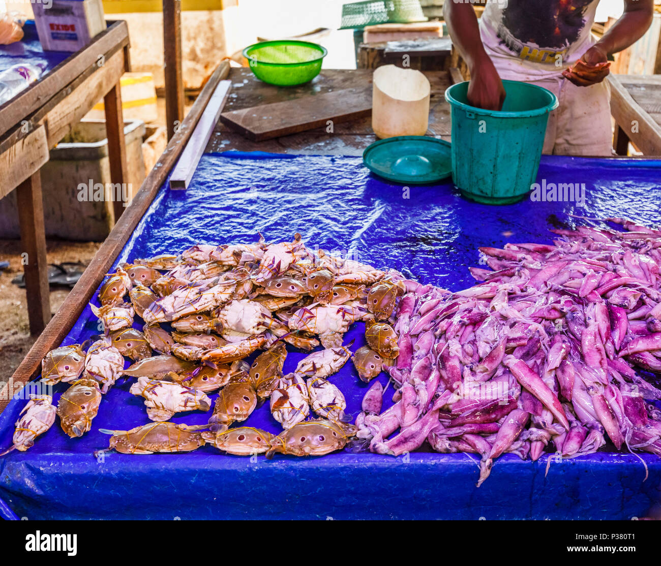 Beach fish market stall selling freshly locally caught crabs and squid ...