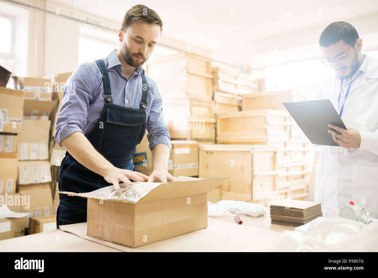 Teamwork at Warehouse of Modern Factory Stock Photo - Alamy