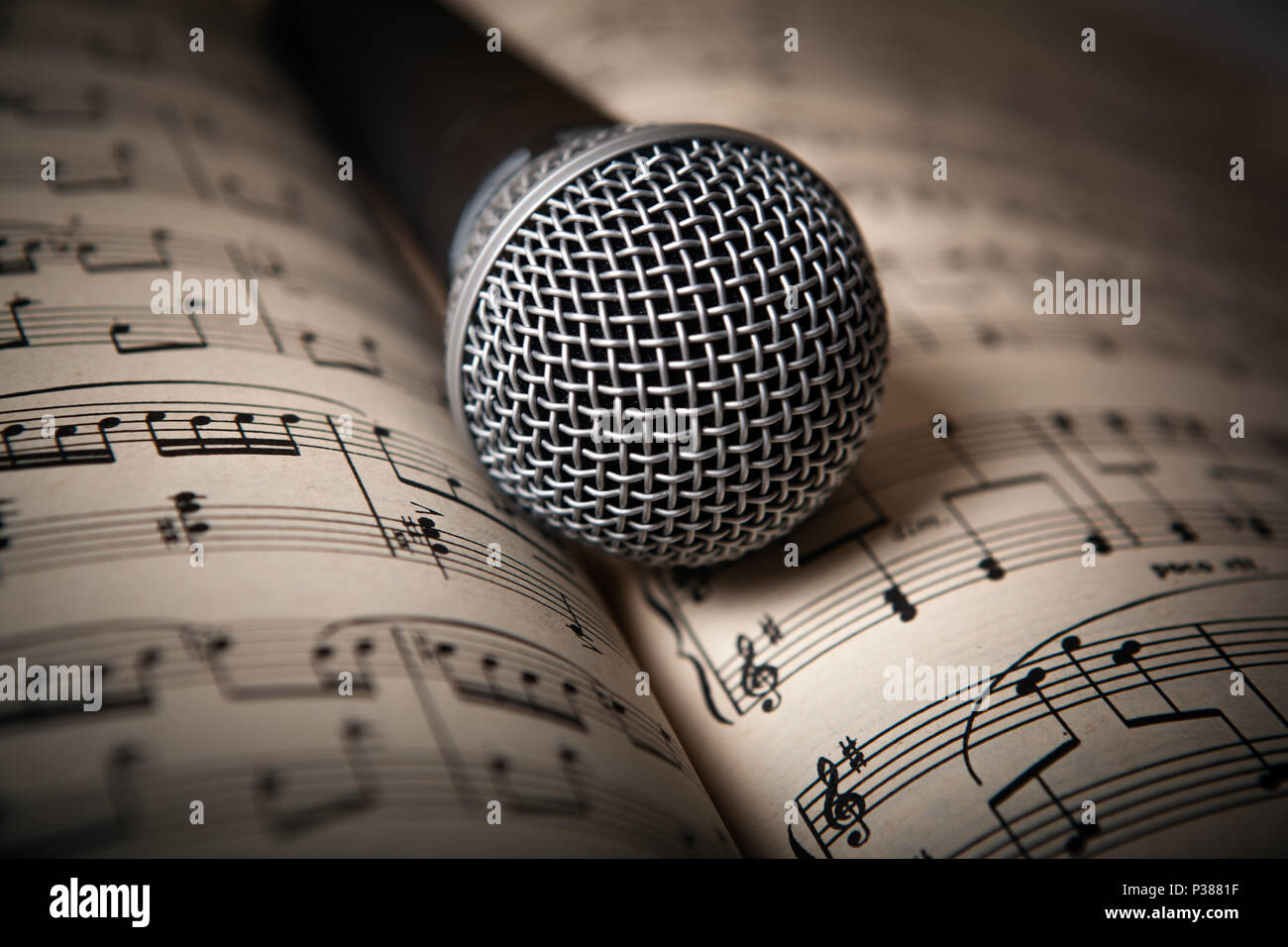 microphone lies on the music book close up Stock Photo - Alamy