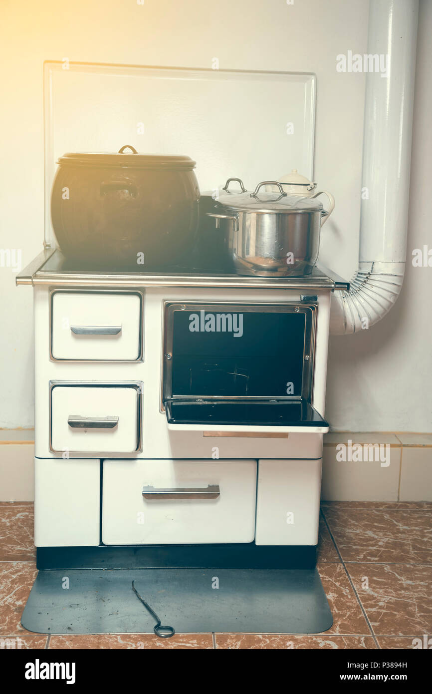 Old wood fire stove with pots, vintage kitchen. Vintage style Stock ...