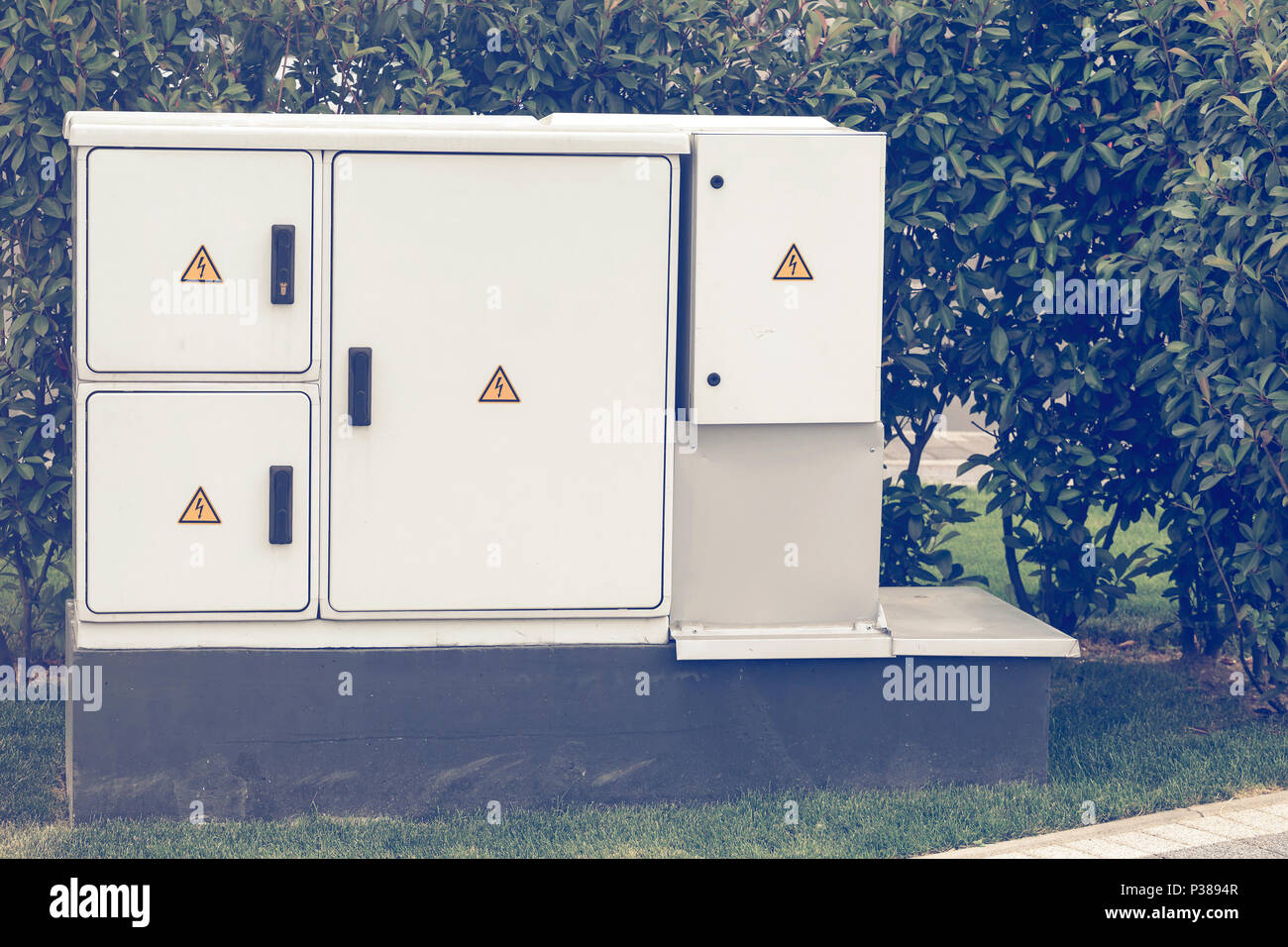 Outdoor plastic electrical cabinet with warning signs. An electrical ...