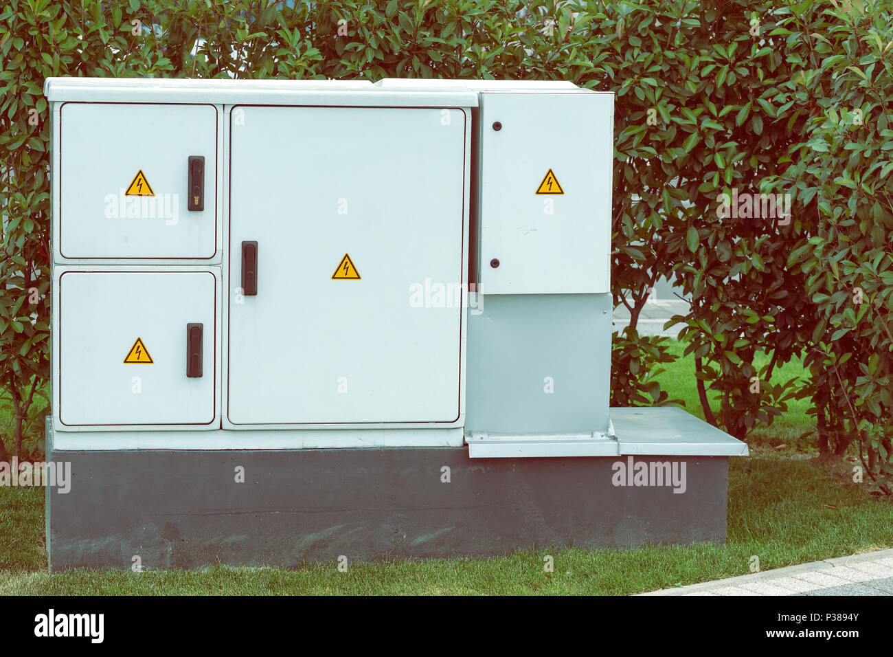 Outdoor plastic electrical cabinet with warning signs. An electrical ...