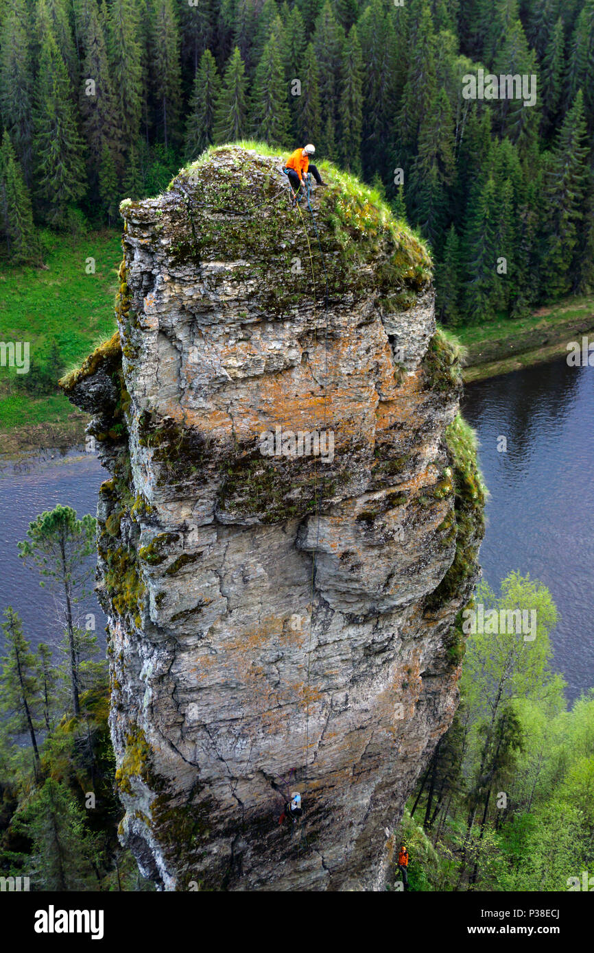 climbers at the top of a steep cliff above the river (rock Devil's ...