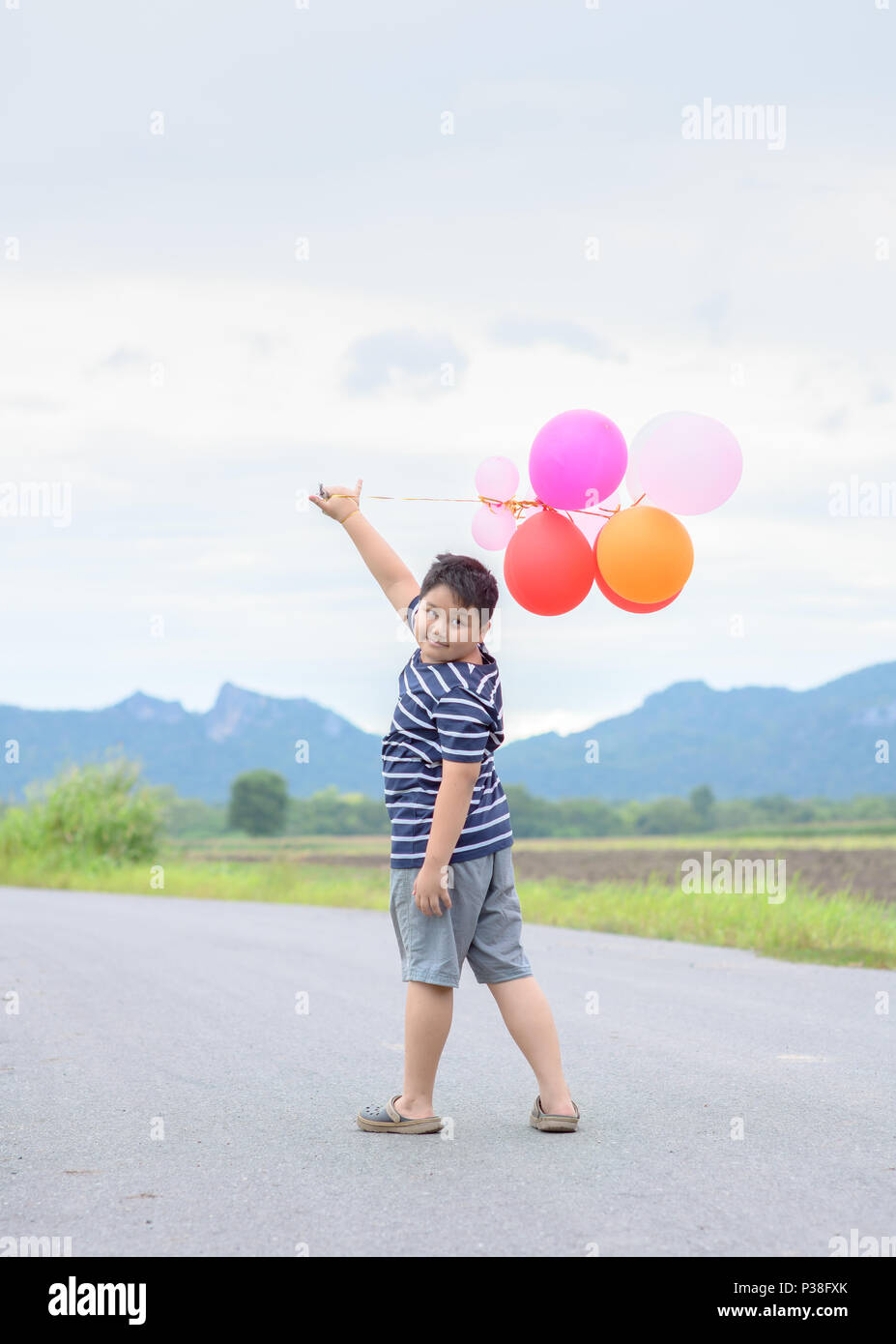 Fat boy with colorful balloon on nature background,Happy and recreation ...