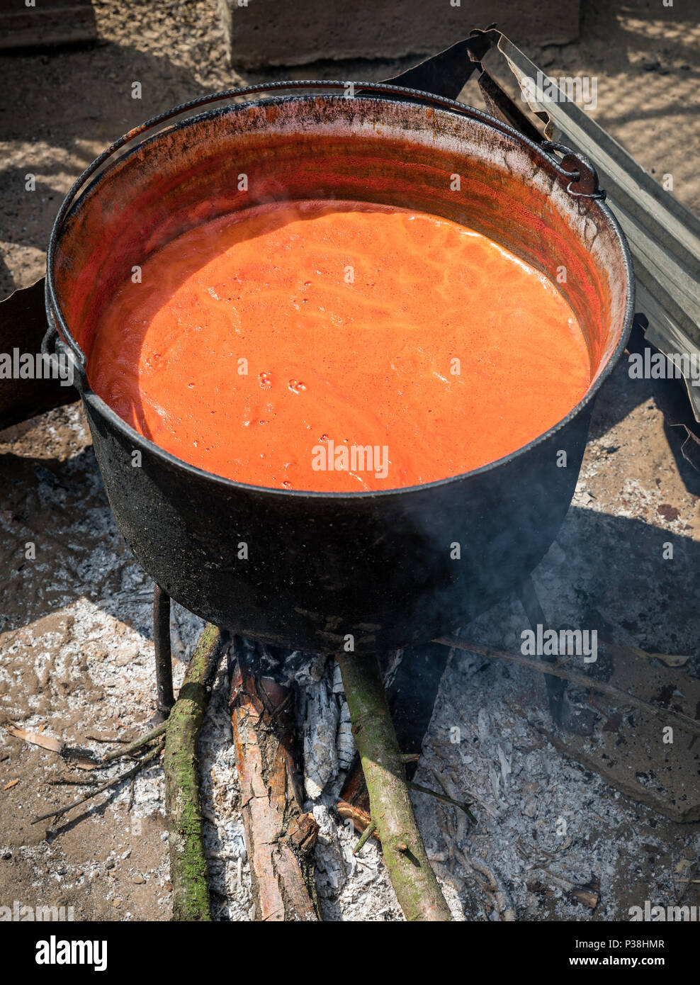 Preparing traditional romanian tomato juice/sause in caldron, boiled ...