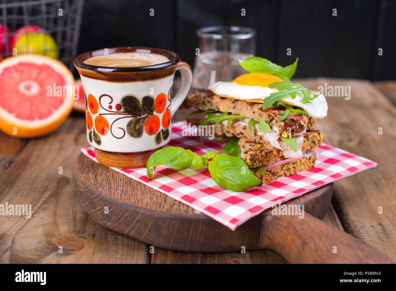 A cup of fragrant coffee and a glass of water. Toast with egg and salad ...
