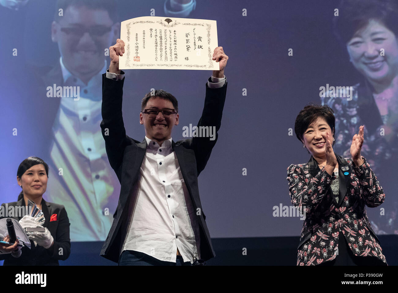 Singaporean director Yee Wei Chai (C) receives the Official Competition Asia International ...